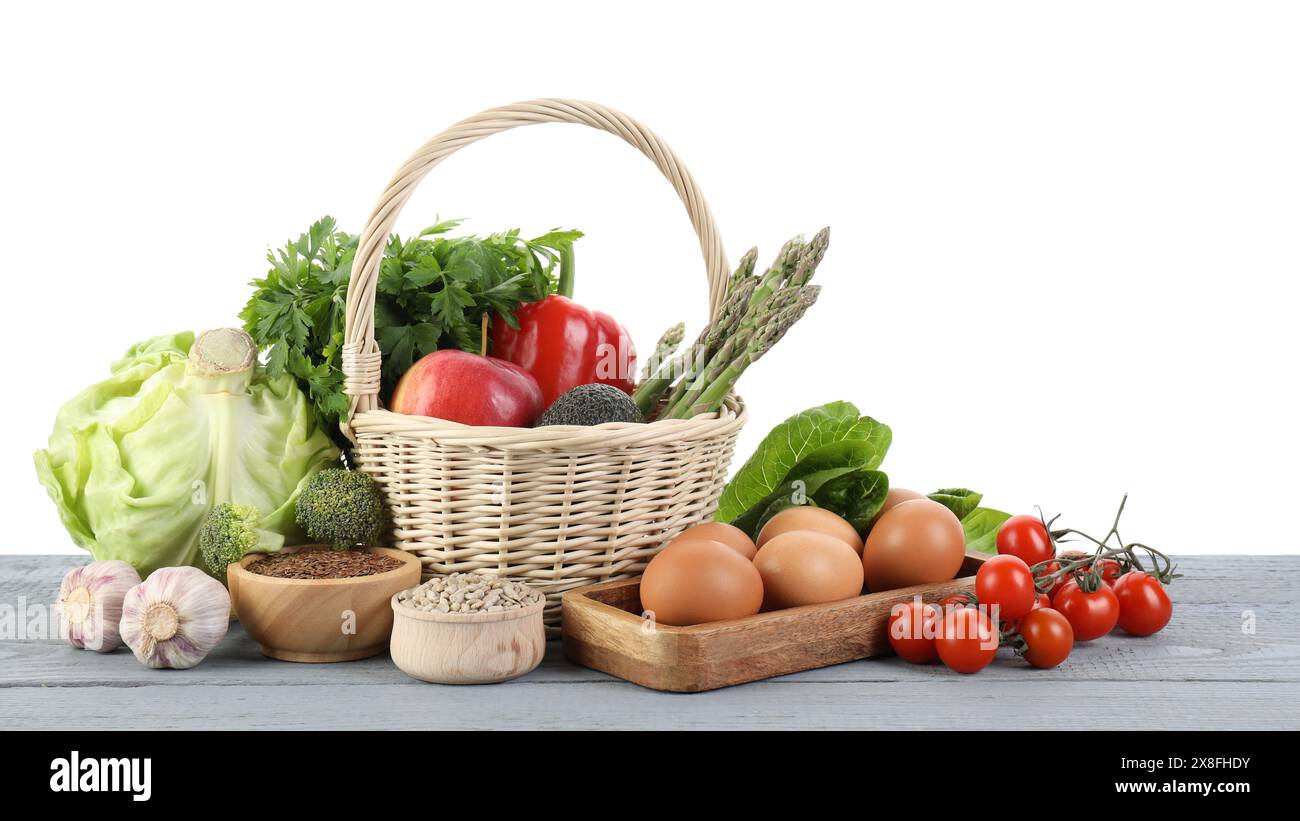 Healthy food. Basket with different fresh products on grey wooden table ...