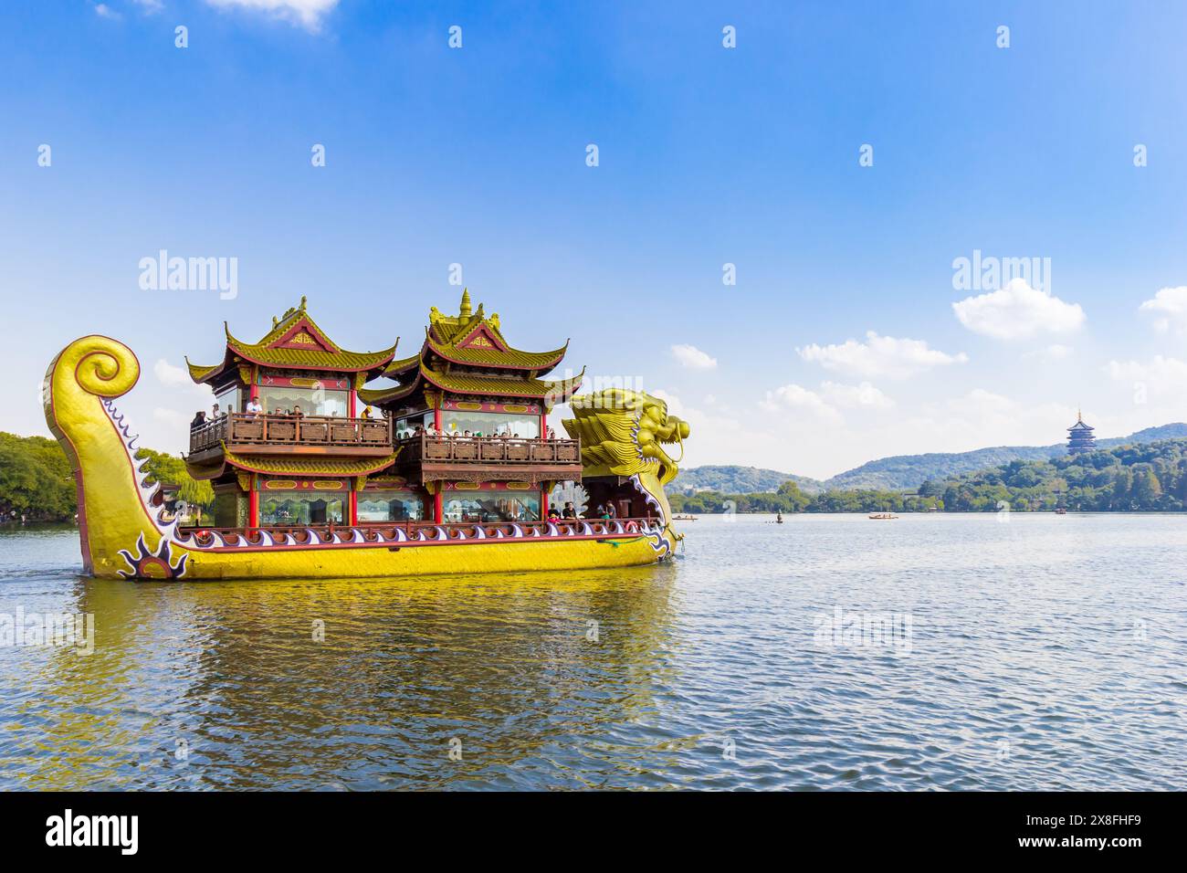 Tourist cruise boat in dragon style on the West lake in Hangzhou, China ...