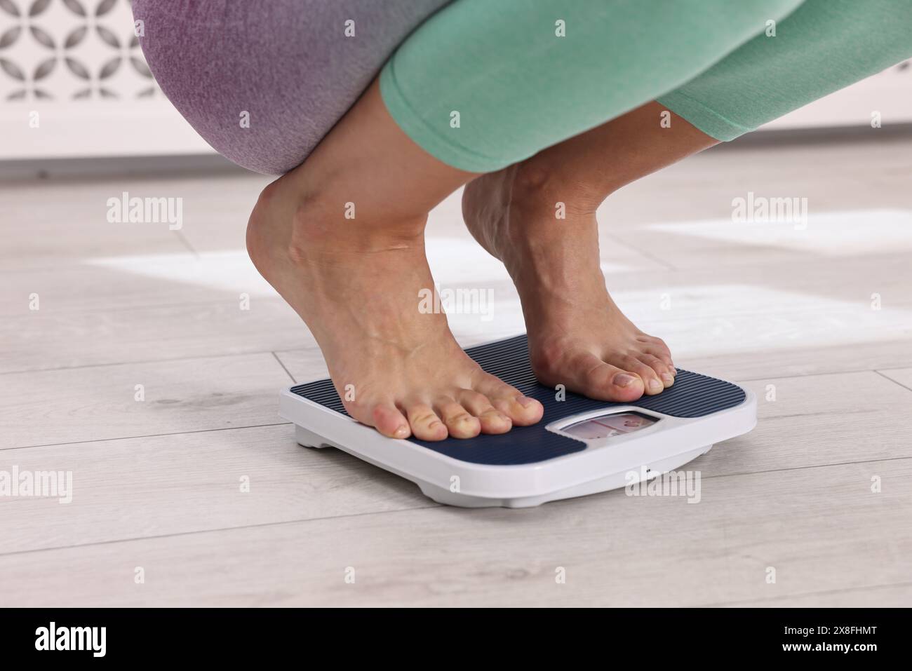 Woman on floor scale at home, closeup. Weight control Stock Photo - Alamy