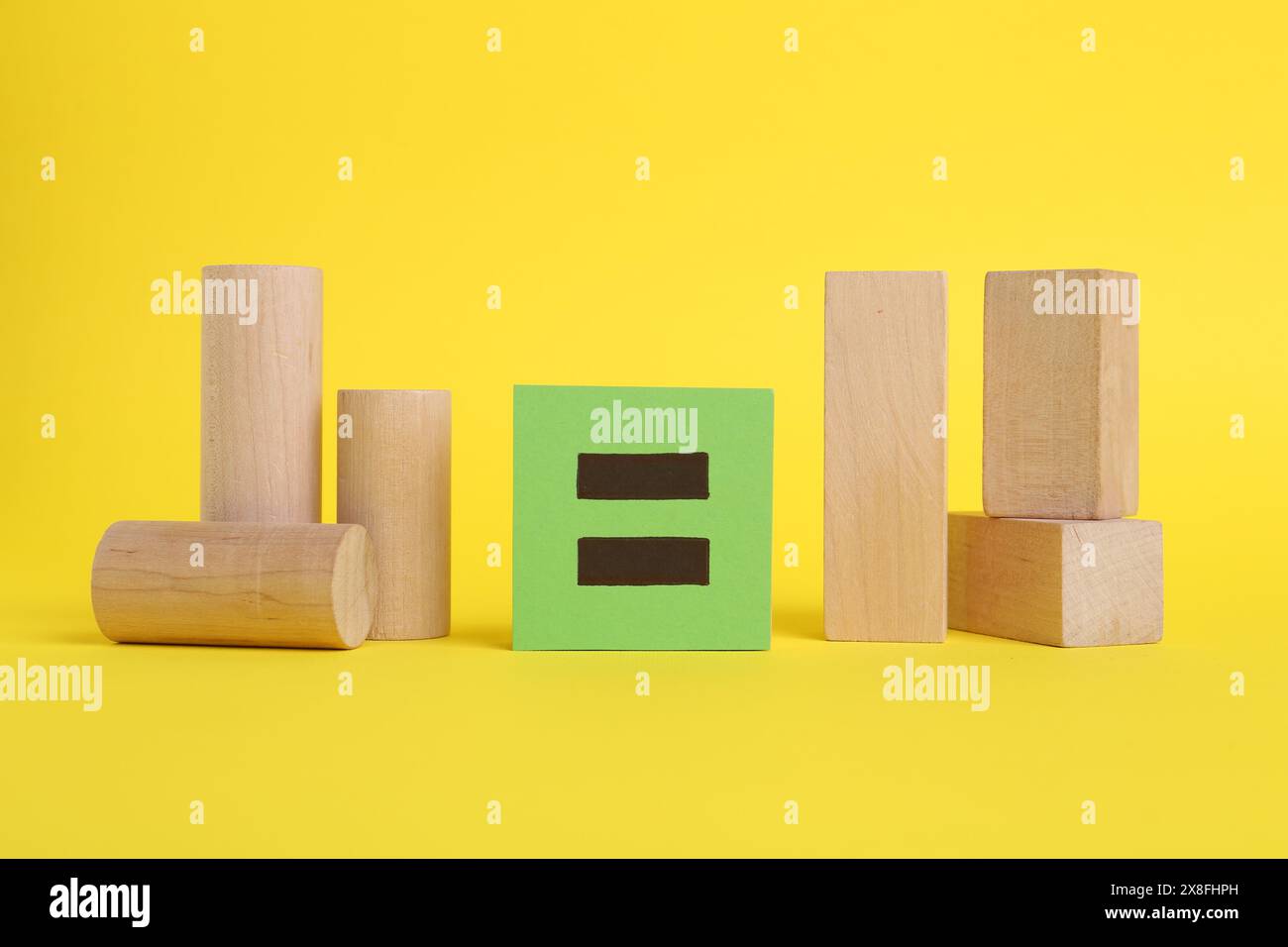 Wooden blocks and equals sign on yellow background Stock Photo - Alamy