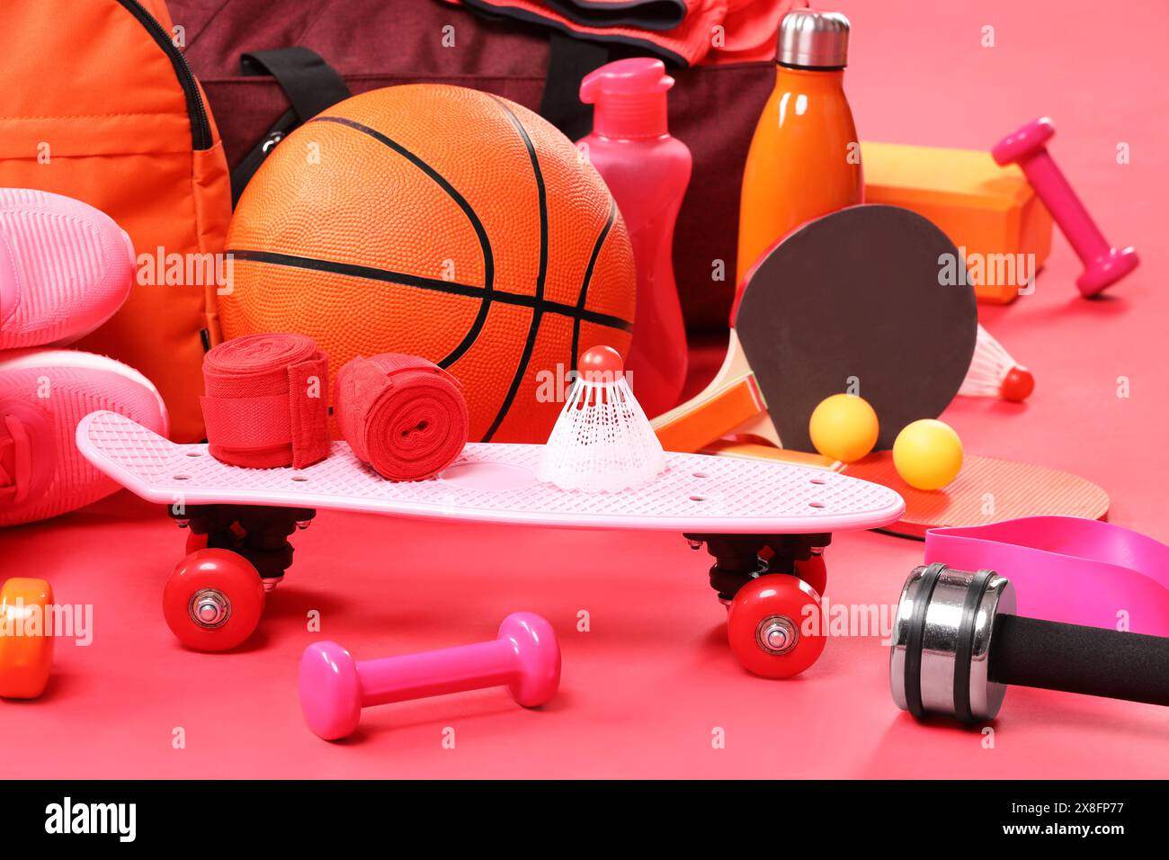 Many different sports equipment on red background Stock Photo - Alamy