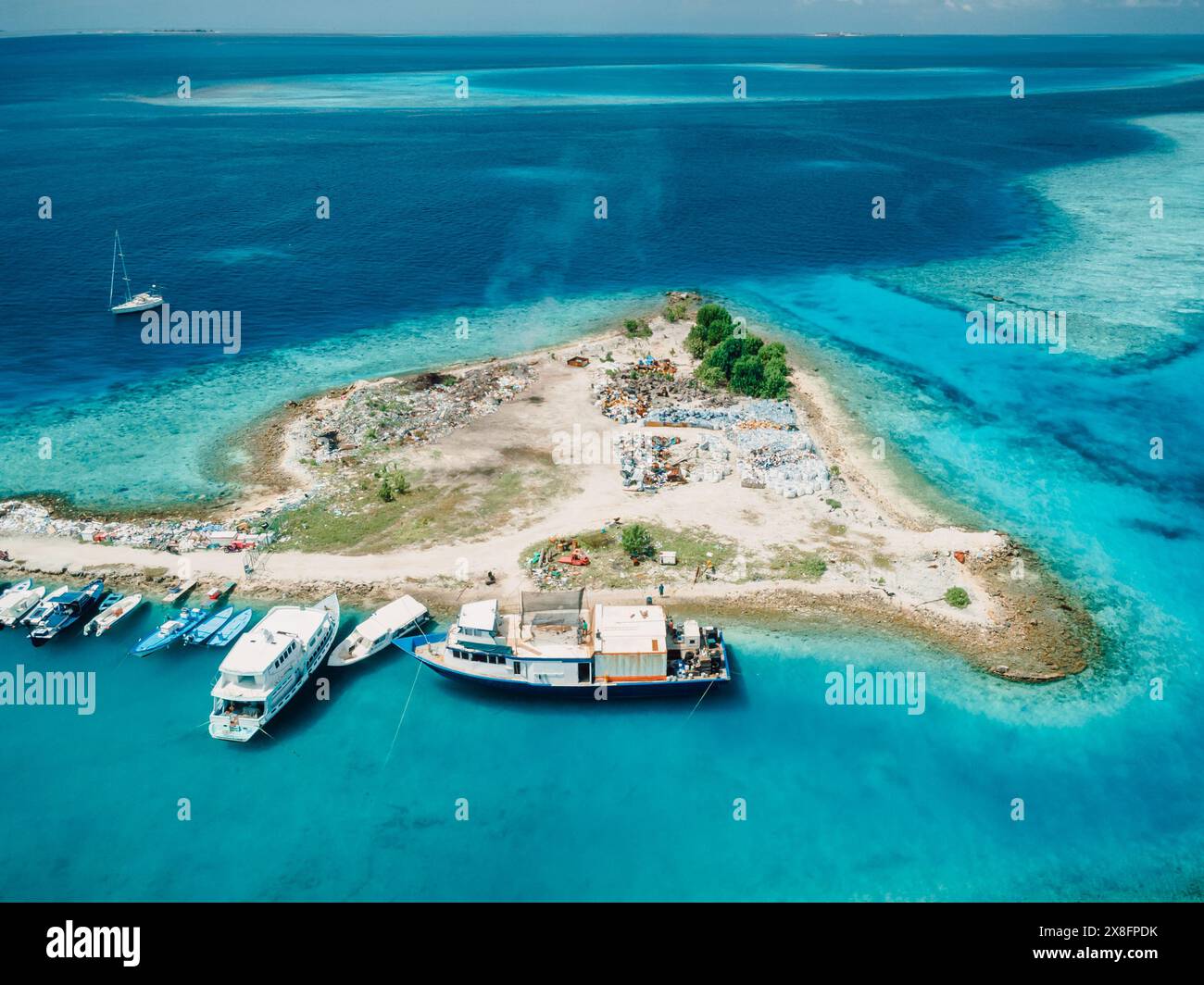 Dump island and yacht harbor in Maldives. Aerial view of pollution by ...