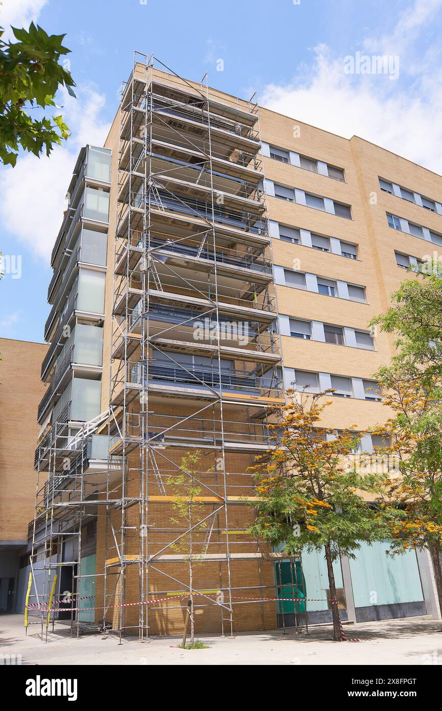 Urban construction scene with scaffolding and insulation on a building ...