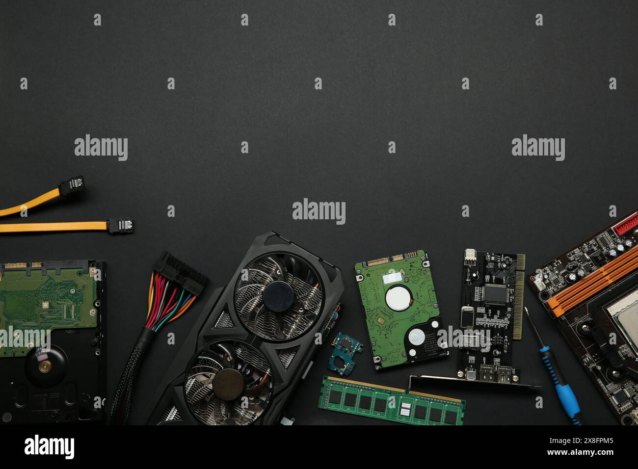Graphics card and other computer hardware on black background, flat lay ...