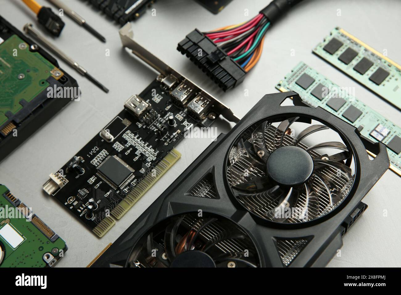 Graphics card and other computer hardware on gray textured background ...