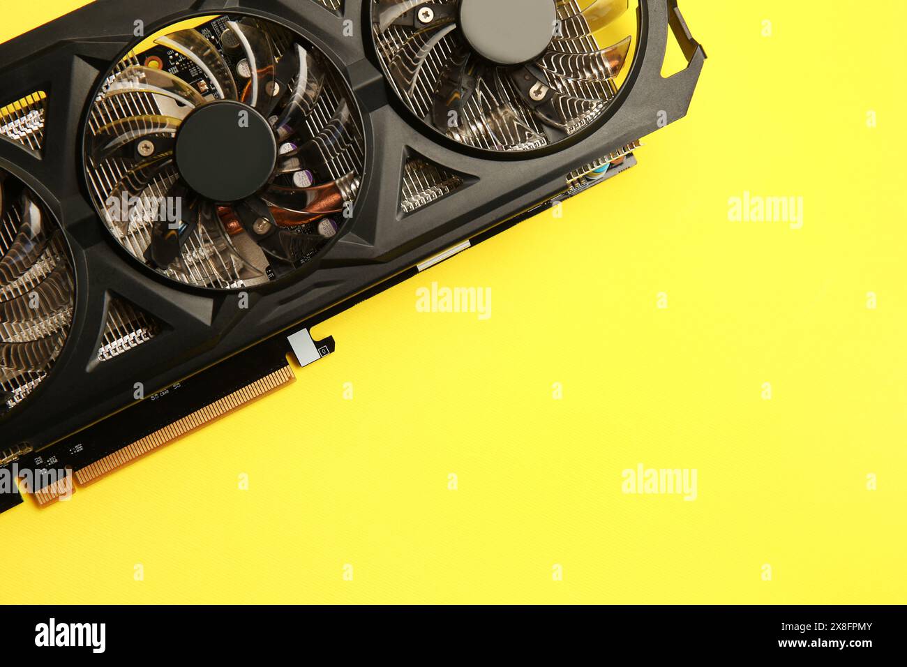 One graphics card on yellow background, top view. Space for text Stock ...