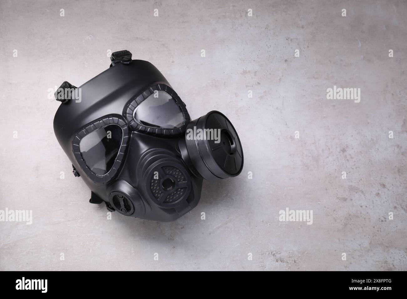 One gas mask on grey textured background, top view. Space for text ...