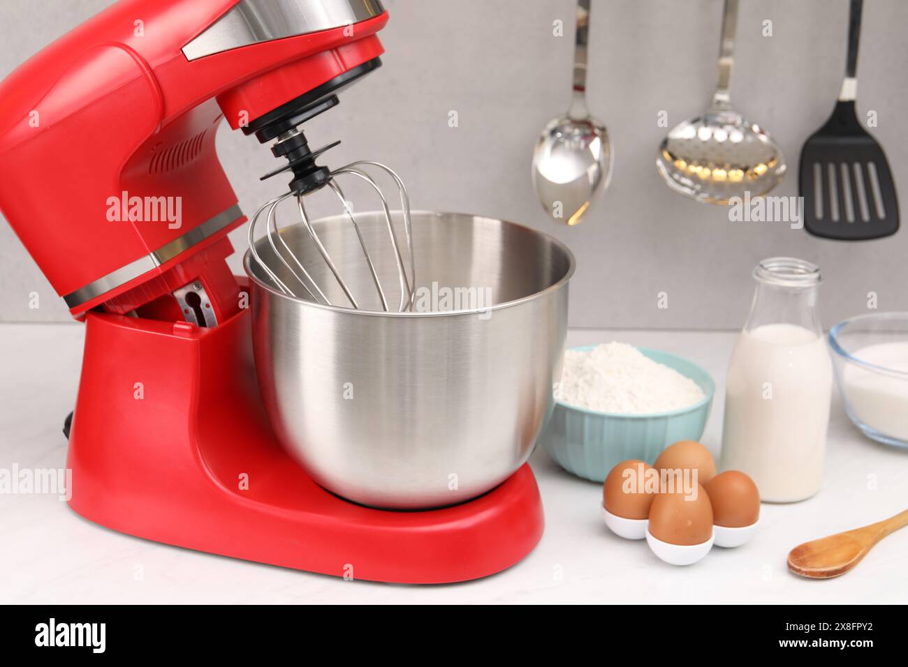 Modern red stand mixer and products on white table in kitchen Stock ...