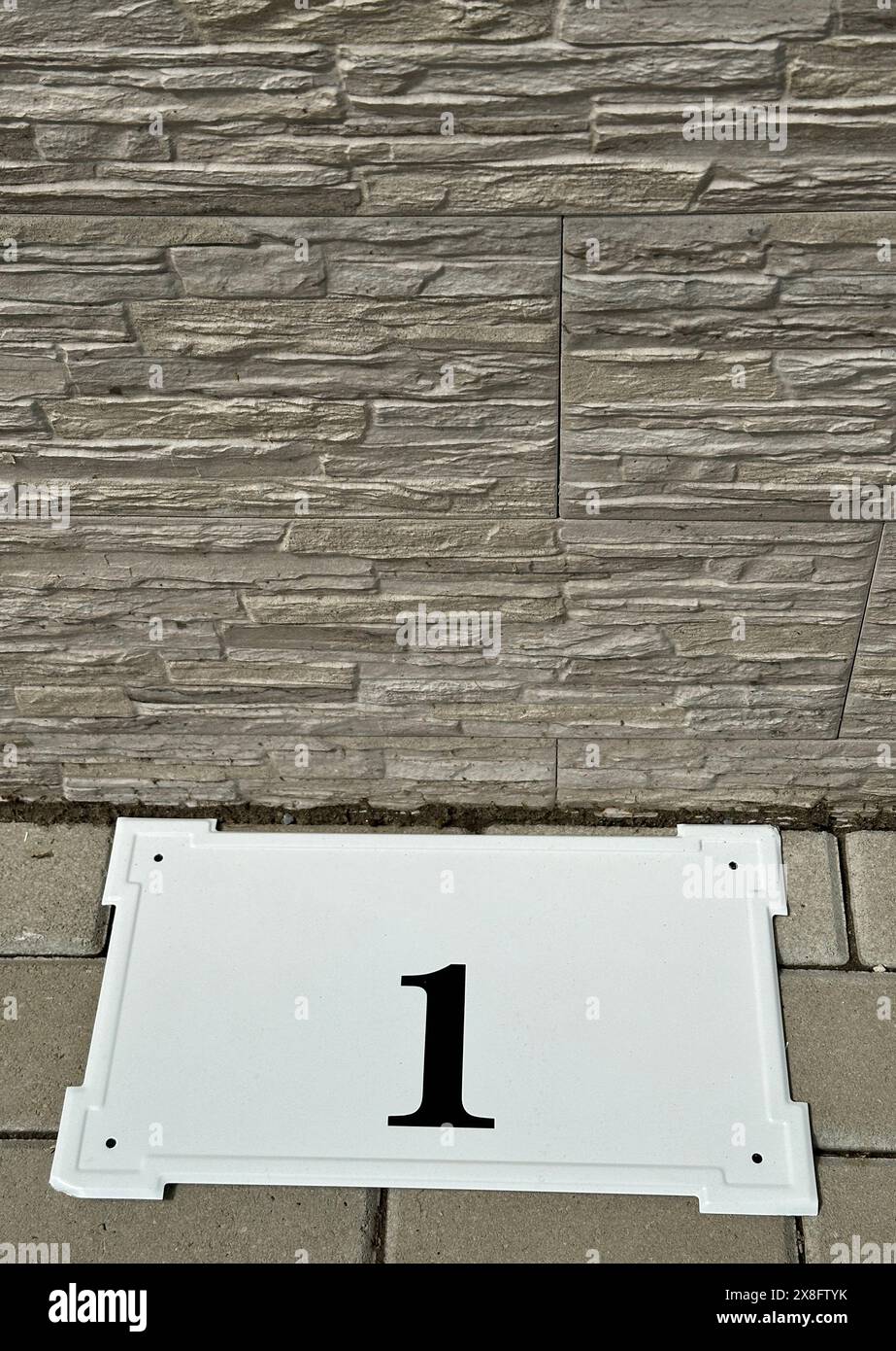 House number plate next to the wall of a building Stock Photo - Alamy