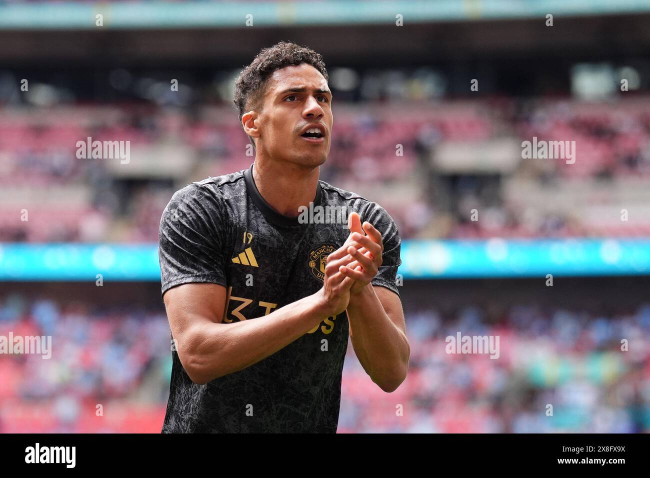 Manchester United's Raphael Varane gestures towards the crowd ahead of ...