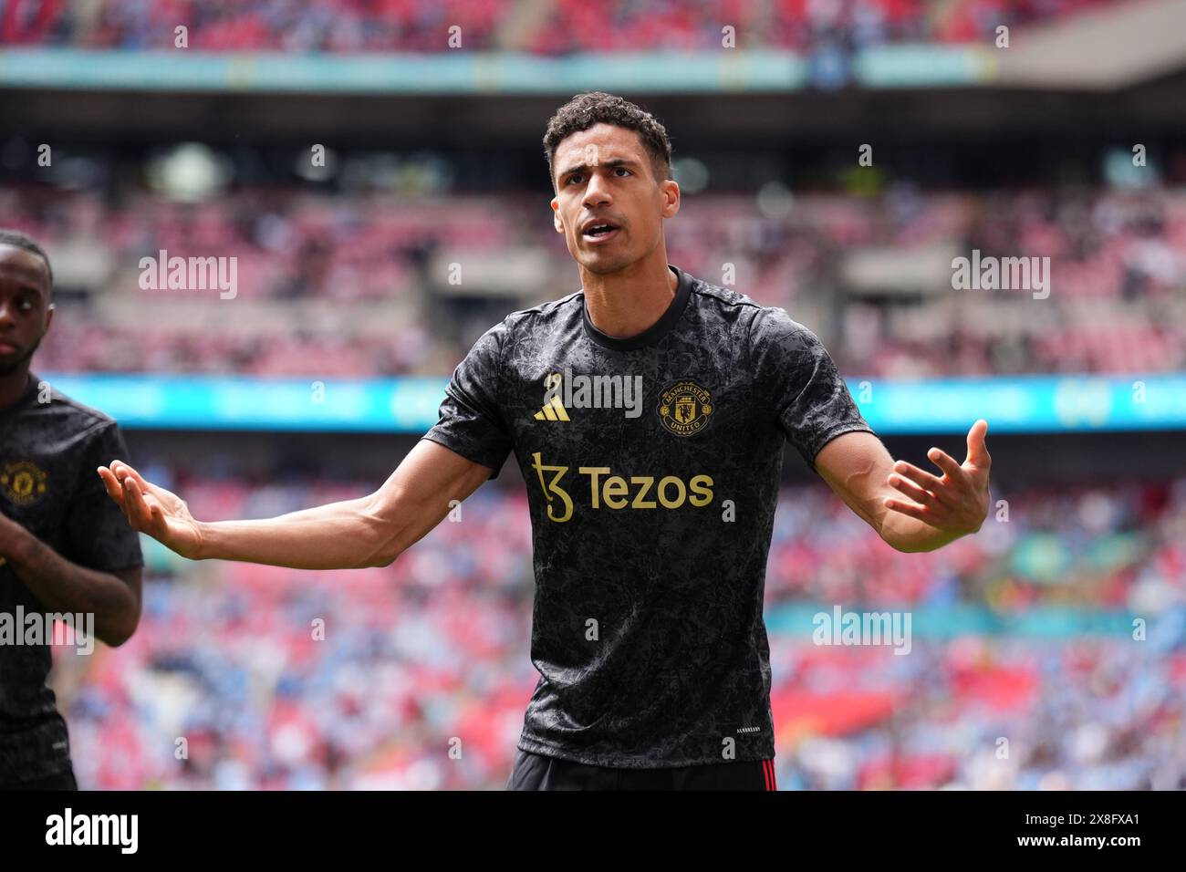 Manchester United's Raphael Varane gestures towards the crowd ahead of ...