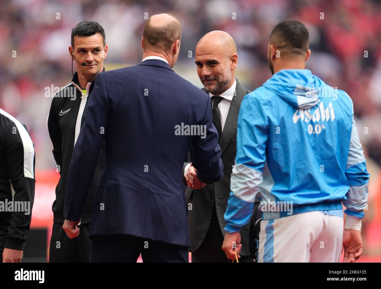 The Prince of Wales shakes hands with Manchester City manager Pep ...