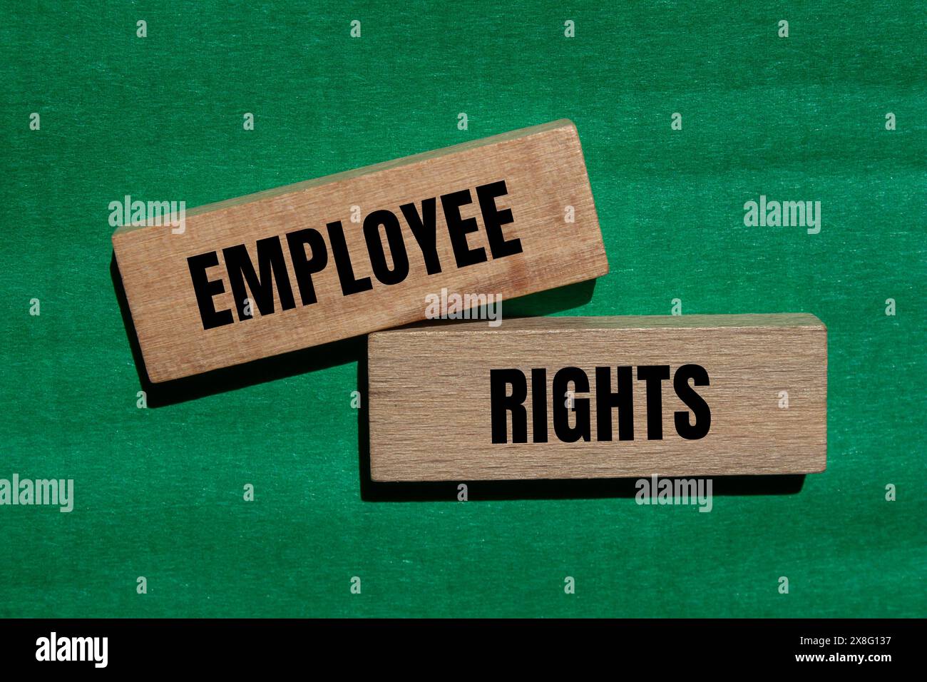 Employee rights words written on wooden blocks with green background ...