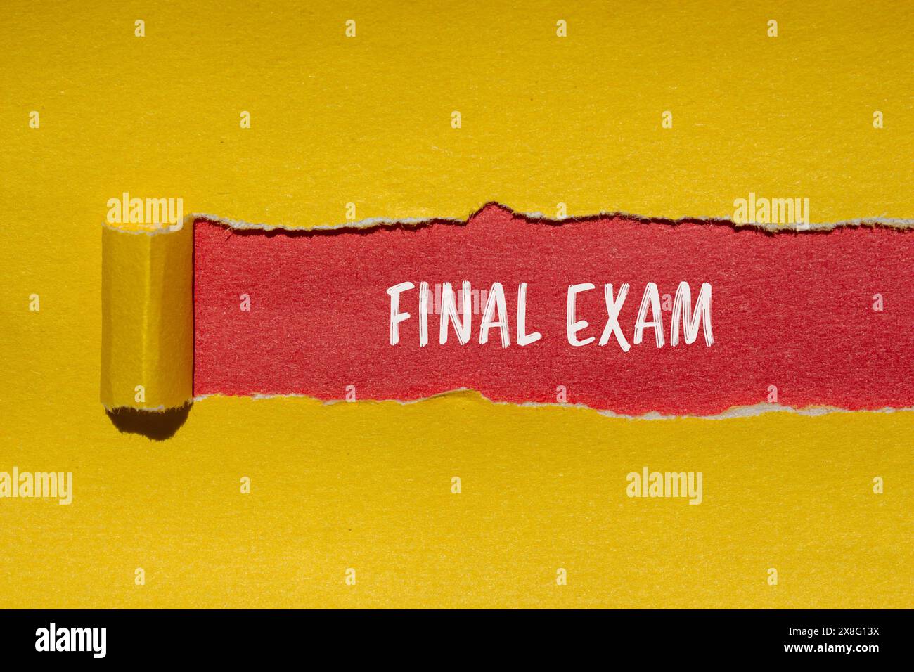 Final exam words written on ripped yellow paper with red background ...