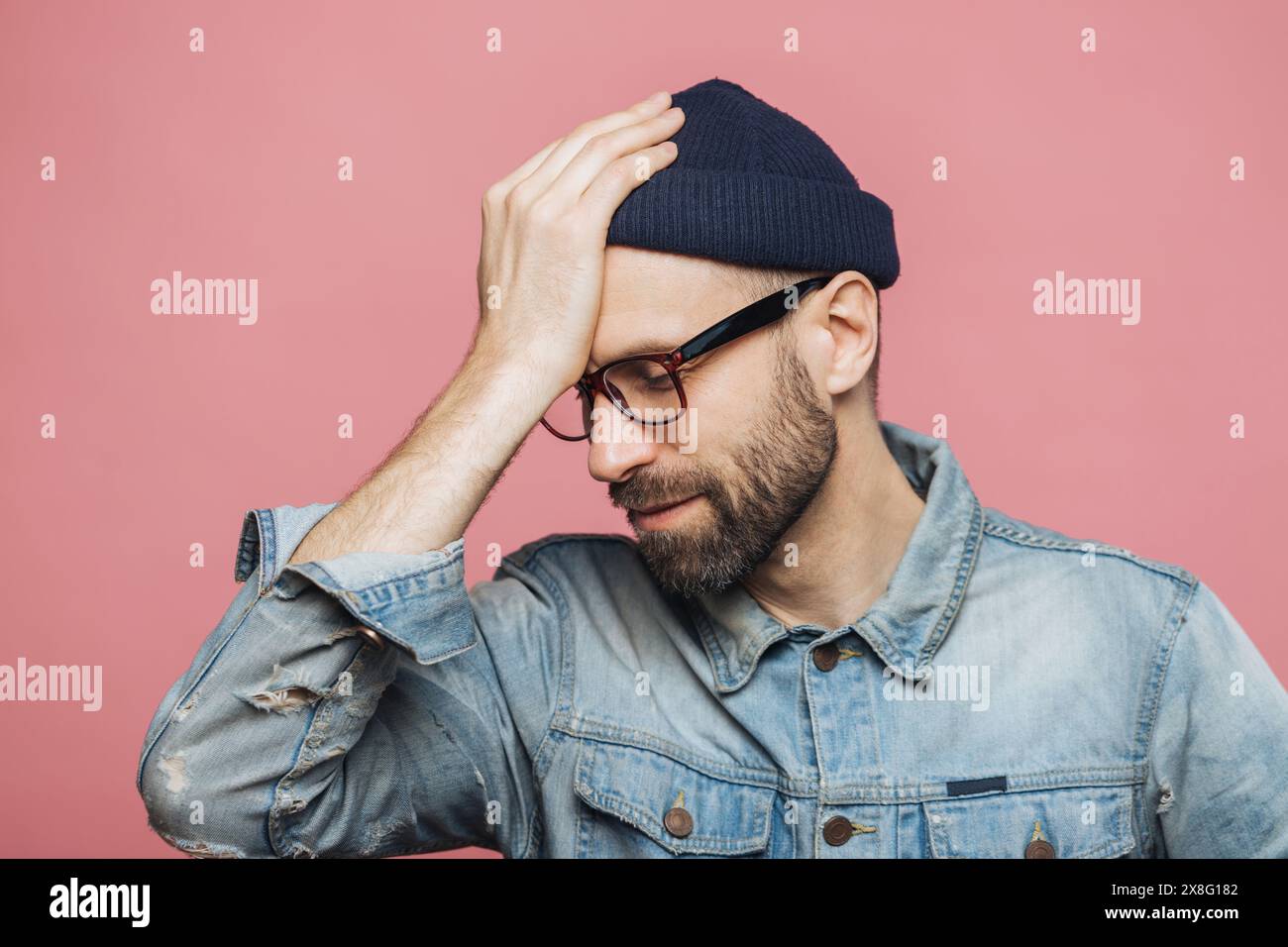 Man with hand on forehead in a dramatic pose, evoking thoughtful ...