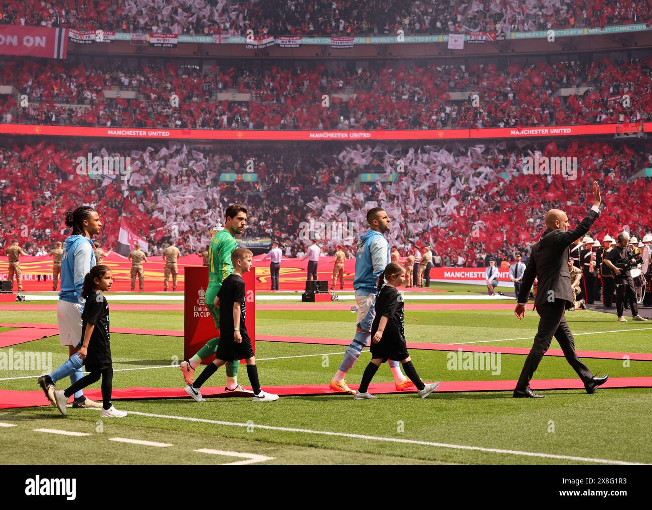 London, UK. 25th May, 2024. Manchester City walk out in what appears to ...