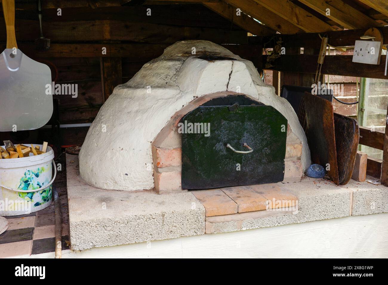 Rustic outdoor pizza oven in wooden shelter, ready for baking homemade ...