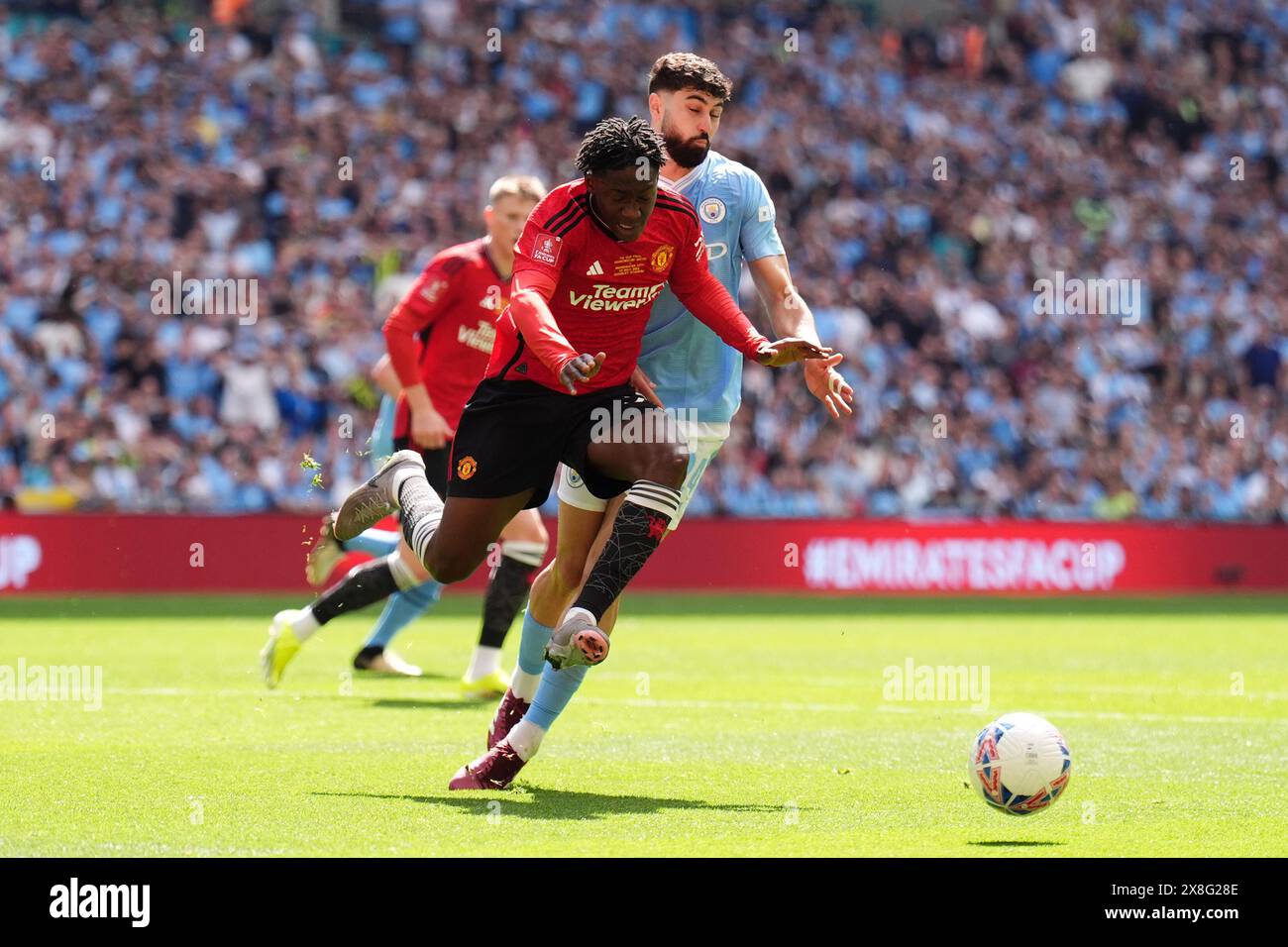 Manchester United's Kobbie Mainoo (left) and Manchester City's Josko ...