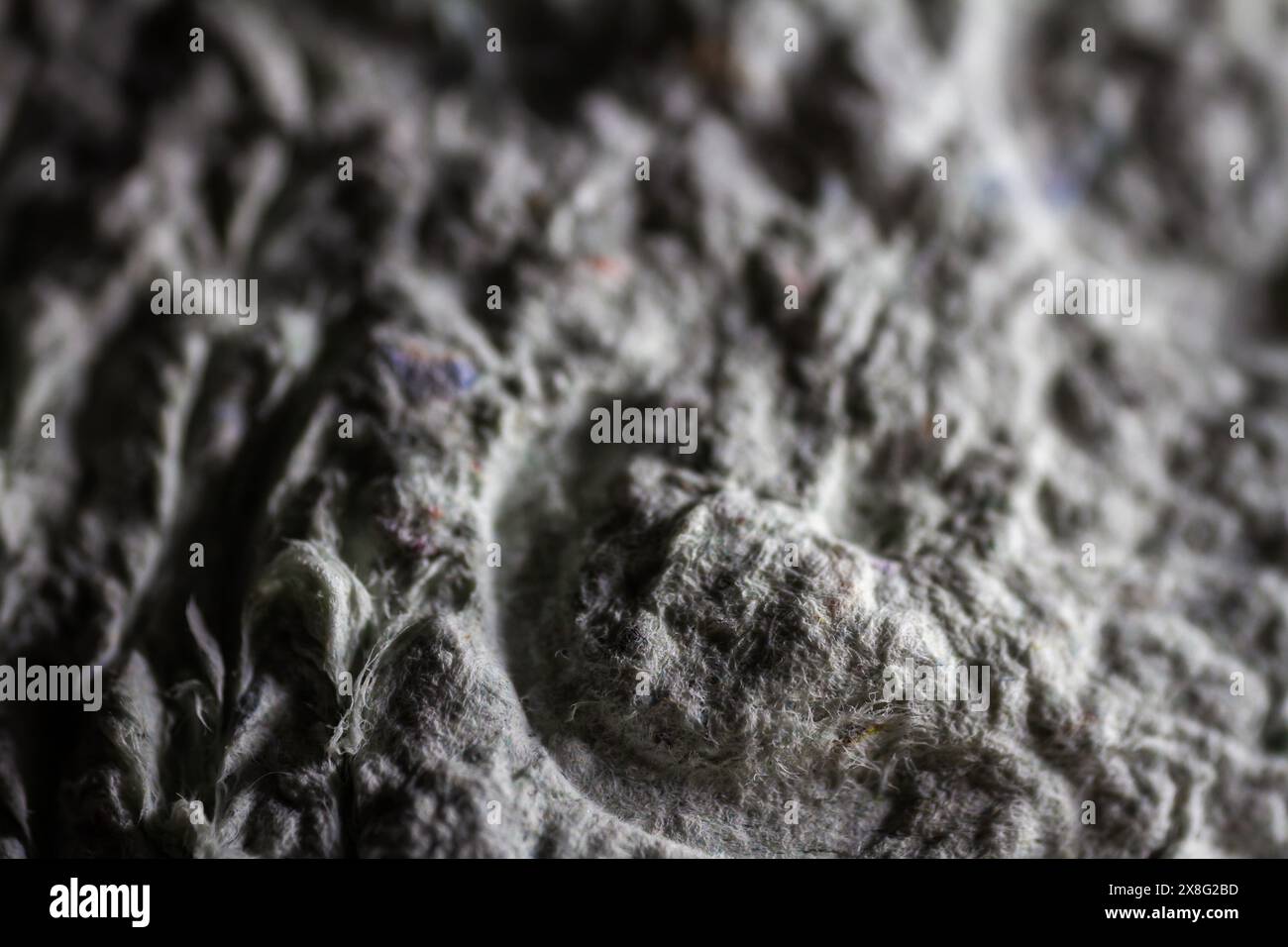 Extreme close up of old gray handmade paper mache with a structure and ...