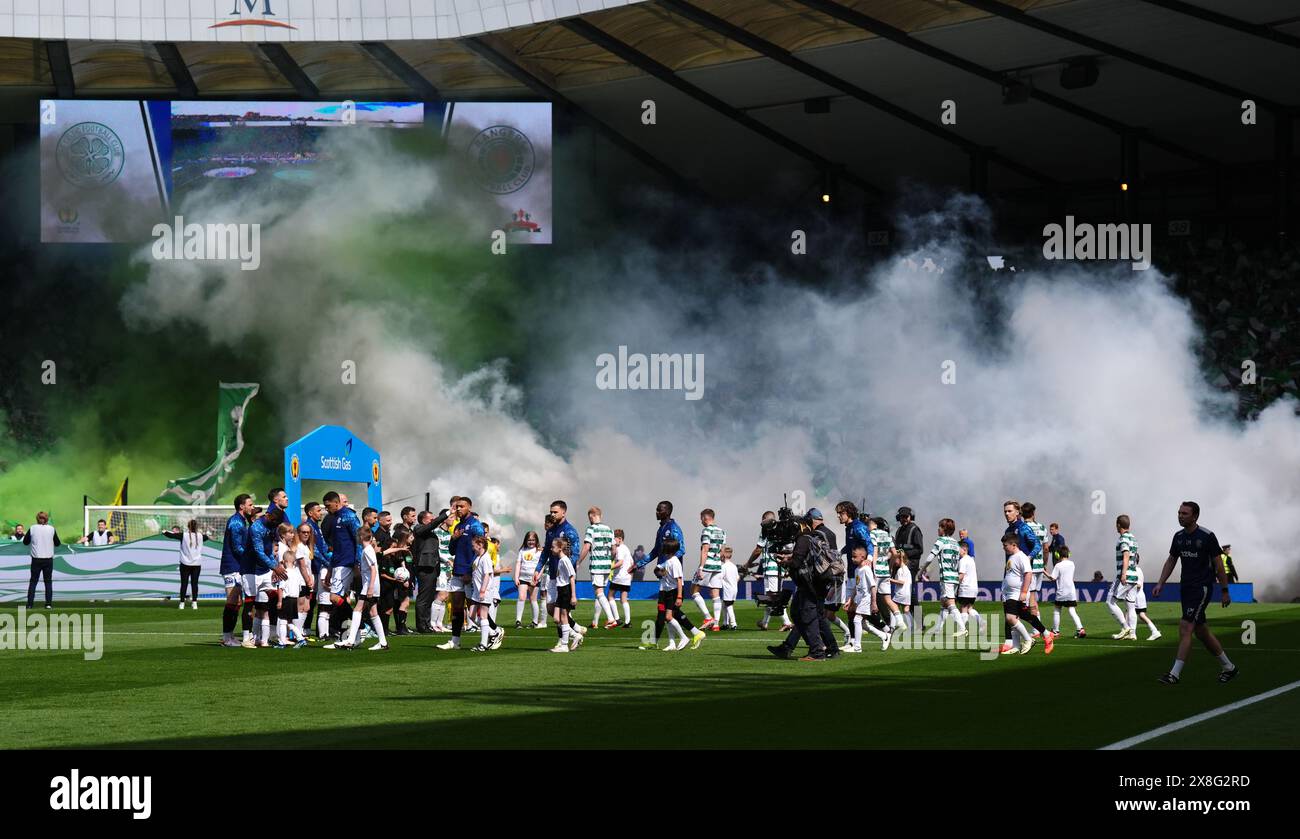 Players and mascots walk on the pitch amid flare smoke ahead of the ...