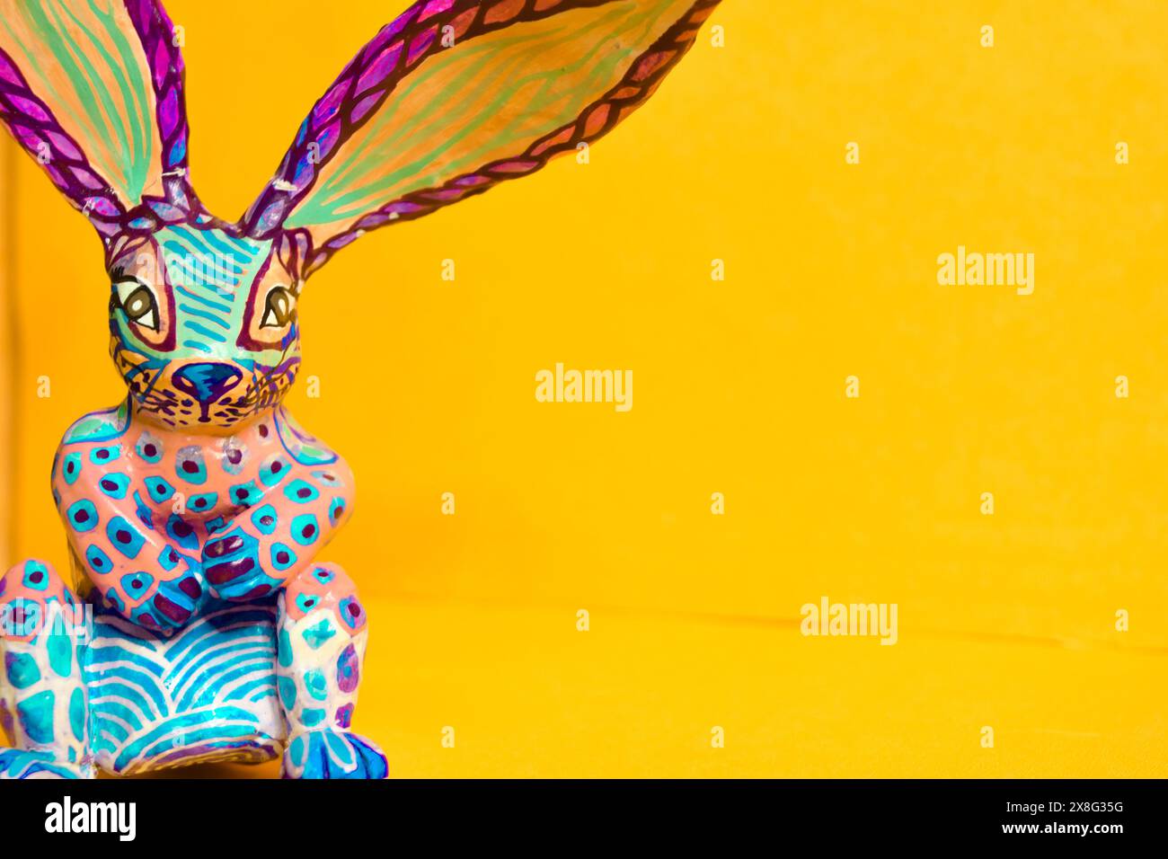 Alebrije rabbit on a yellow background Stock Photo - Alamy