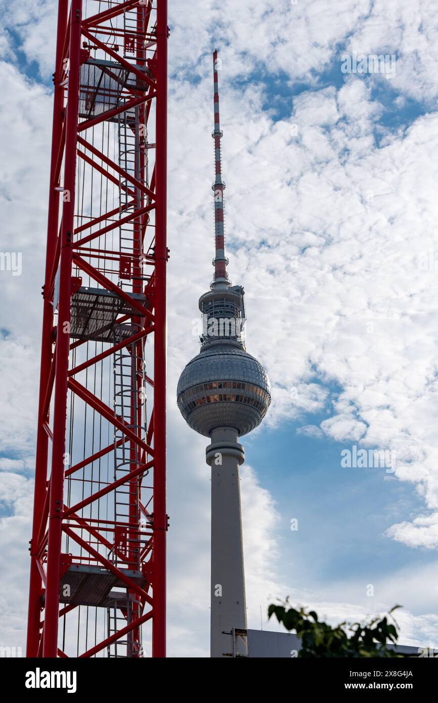 A tall tower with a red top stands in front of a blue sky Stock Photo ...