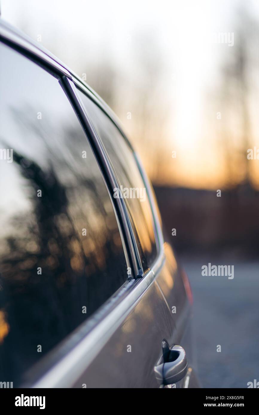 Cardoor window of grey car reflecting sunset and forest in Norway Stock ...