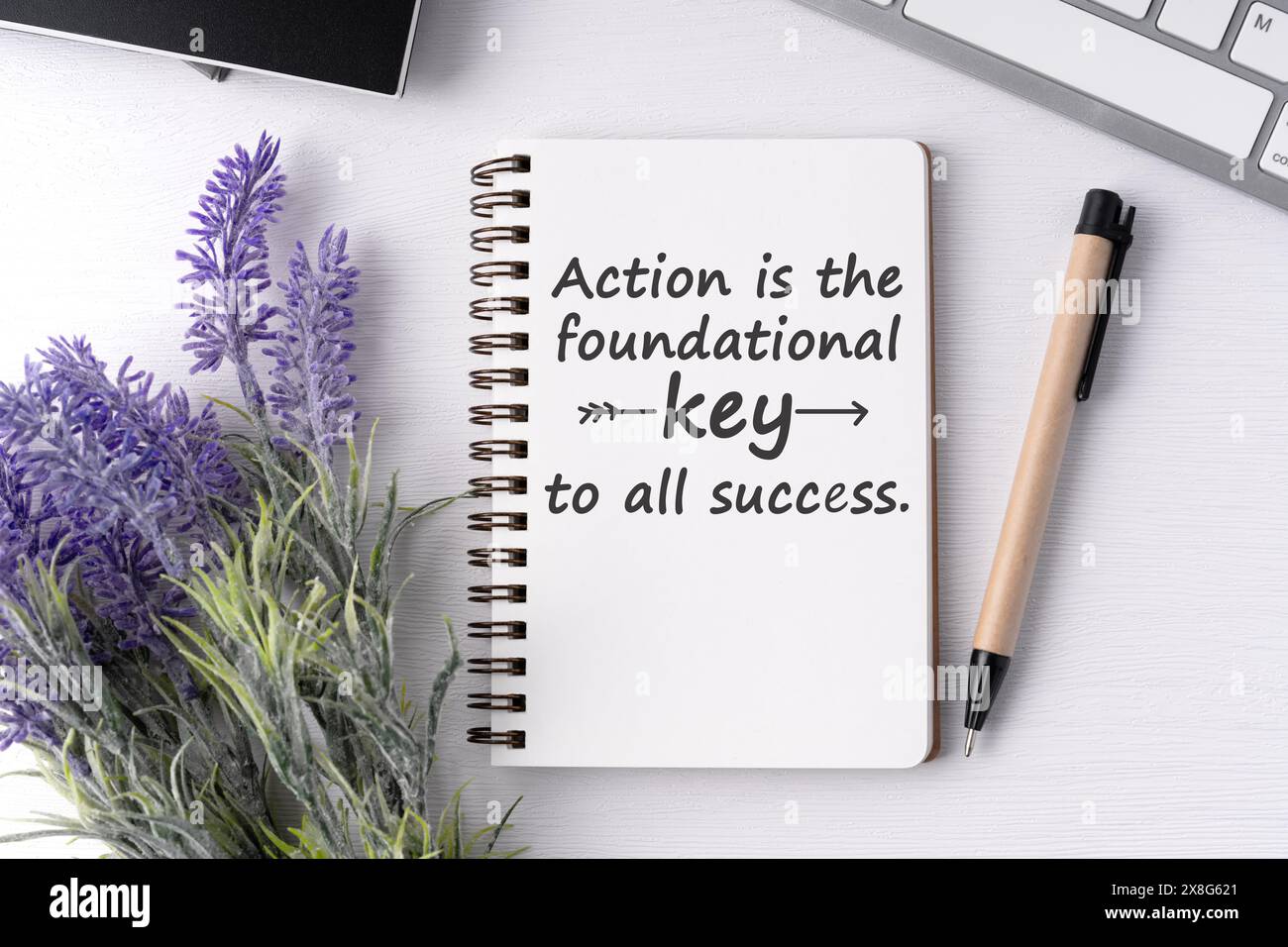 Notepad and inspirational quote action is the foundational key to all ...