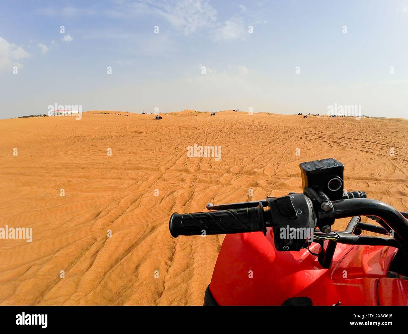 Photography of ATVs driving through red desert in United Arab Emirates ...