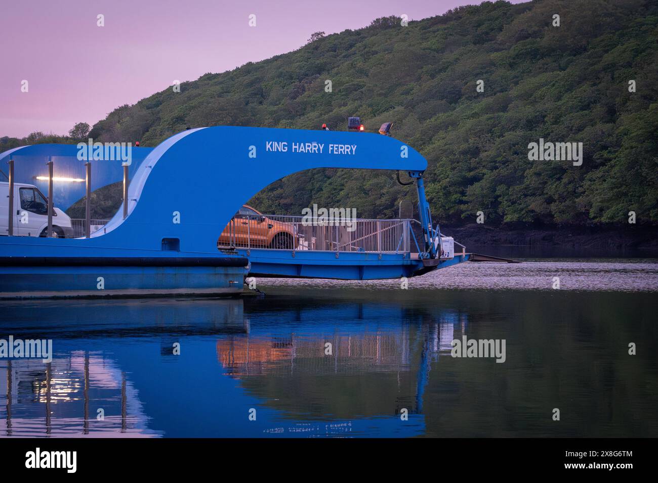 The King Harry chain ferry on a dusk crossing of the River Fal at the ...