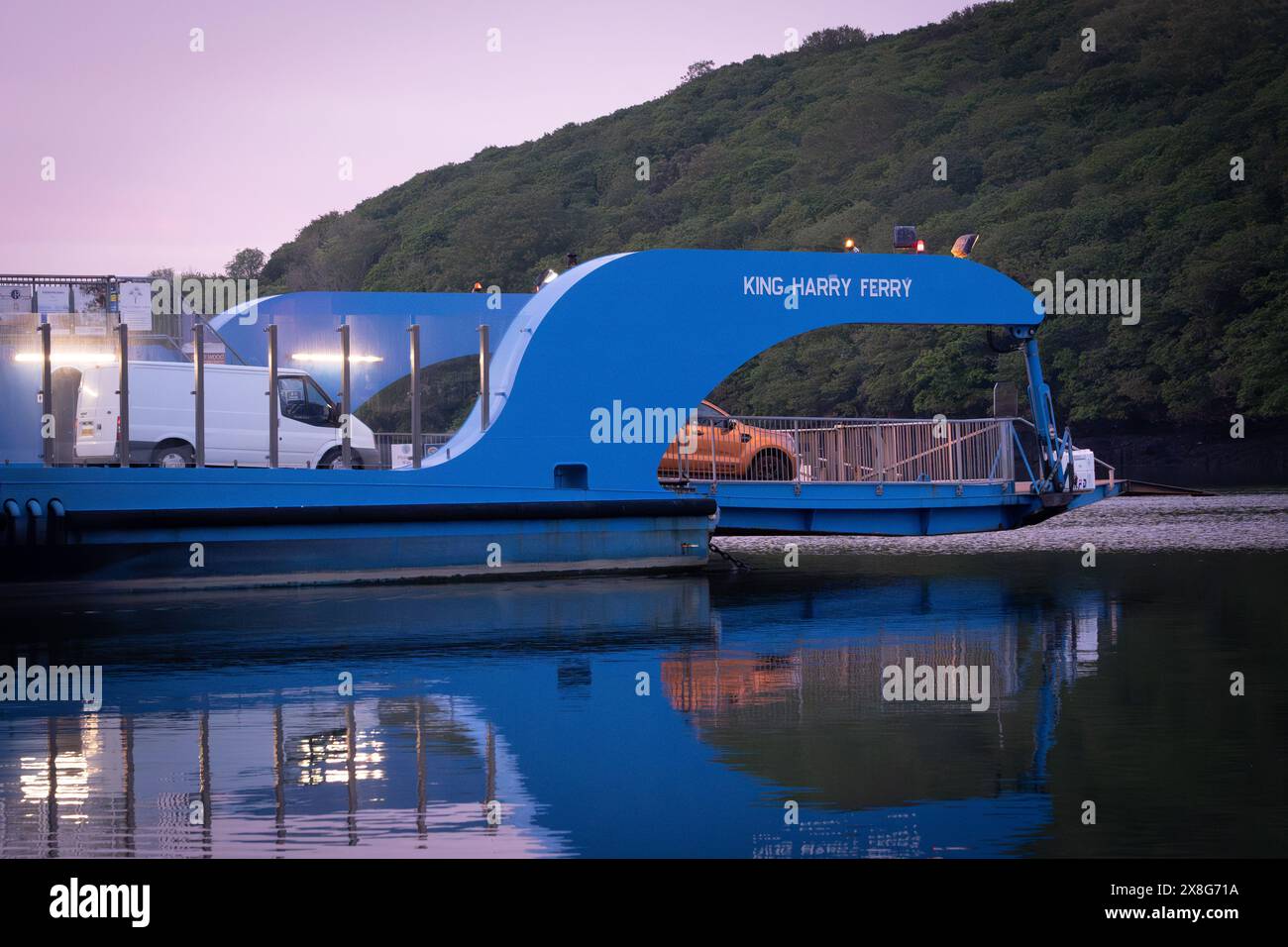 The King Harry chain ferry on a dusk crossing of the River Fal at the ...