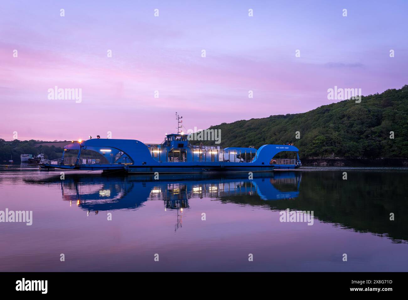 The King Harry chain ferry on a dusk crossing of the River Fal at the ...