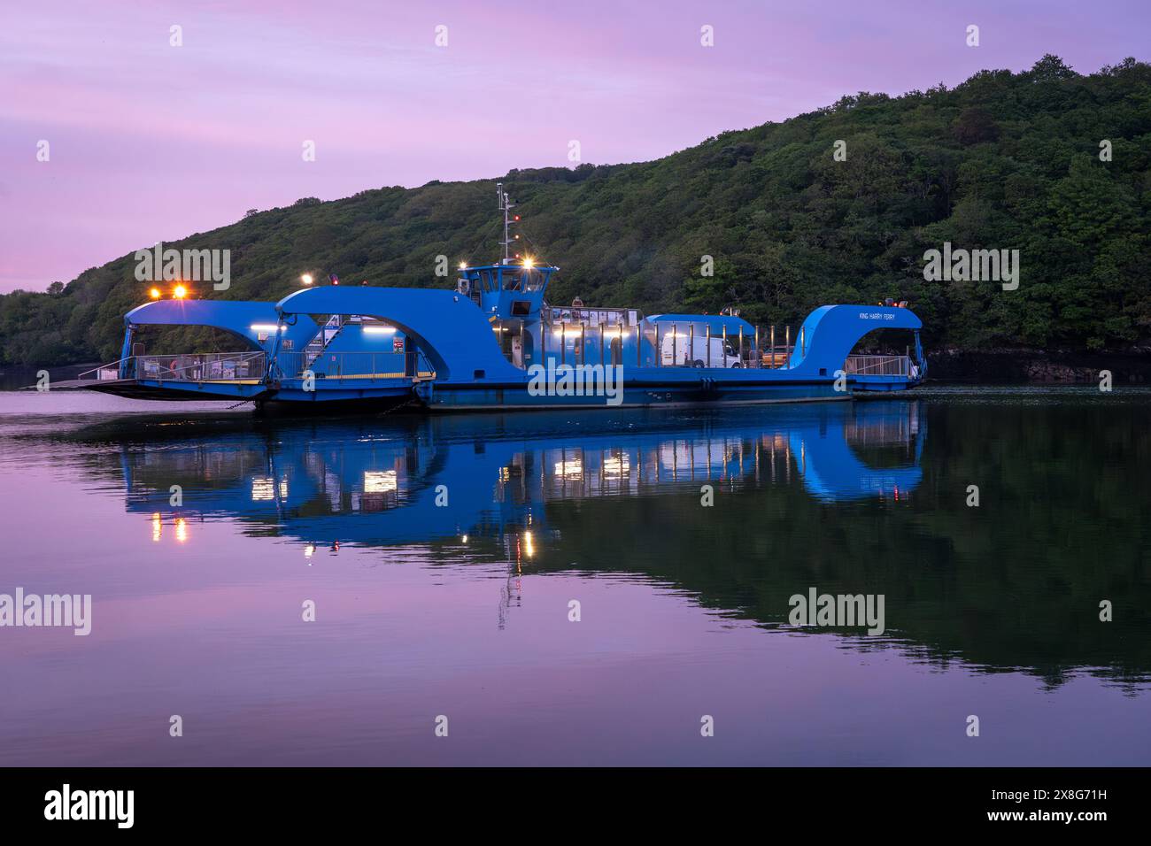 The King Harry chain ferry on a dusk crossing of the River Fal at the ...