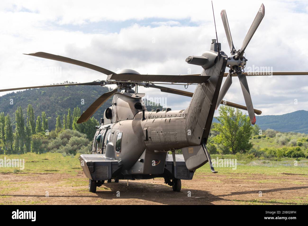 Black painted modern H225M military transport helicopter stationary on ...