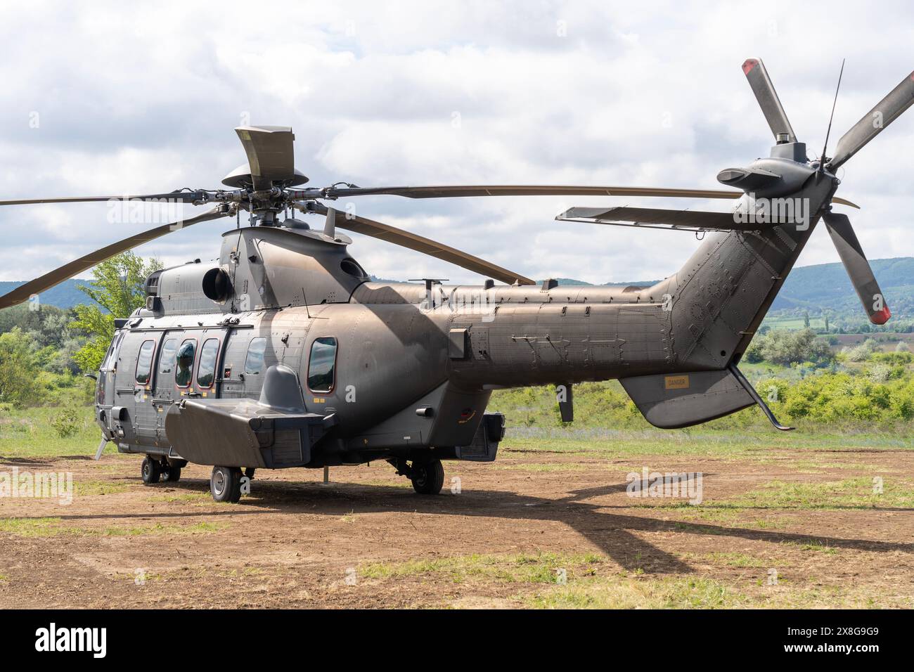 Black painted modern H225M military transport helicopter stationary on ...