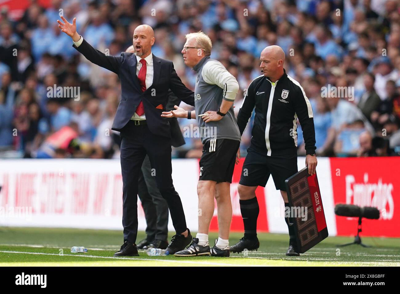Manchester United manager Erik ten Hag (left) and assistant manager ...