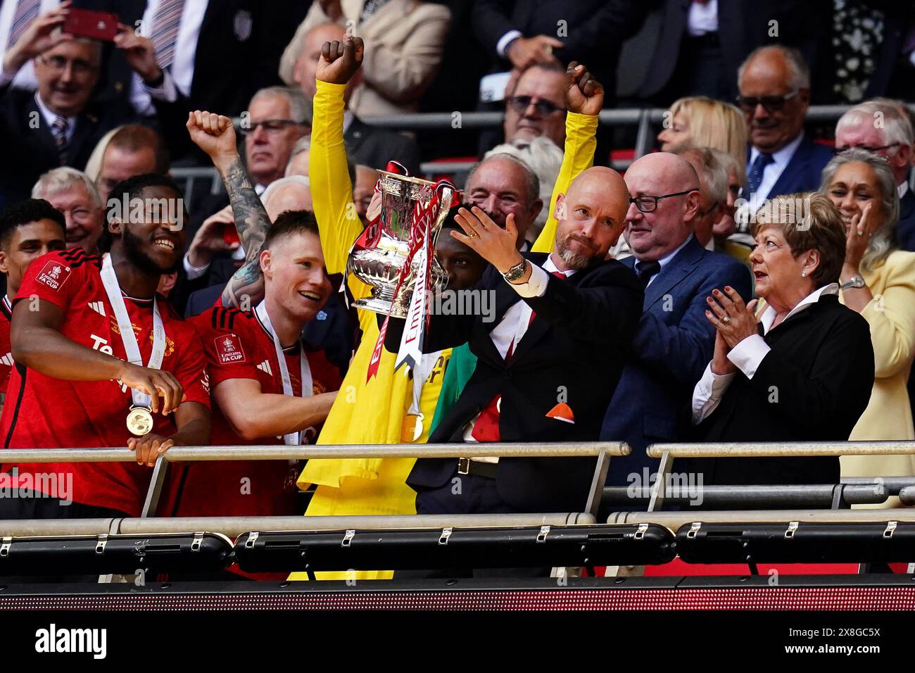 Manchester United manager Erik ten Hag lifts the FA Cup Trophy after ...