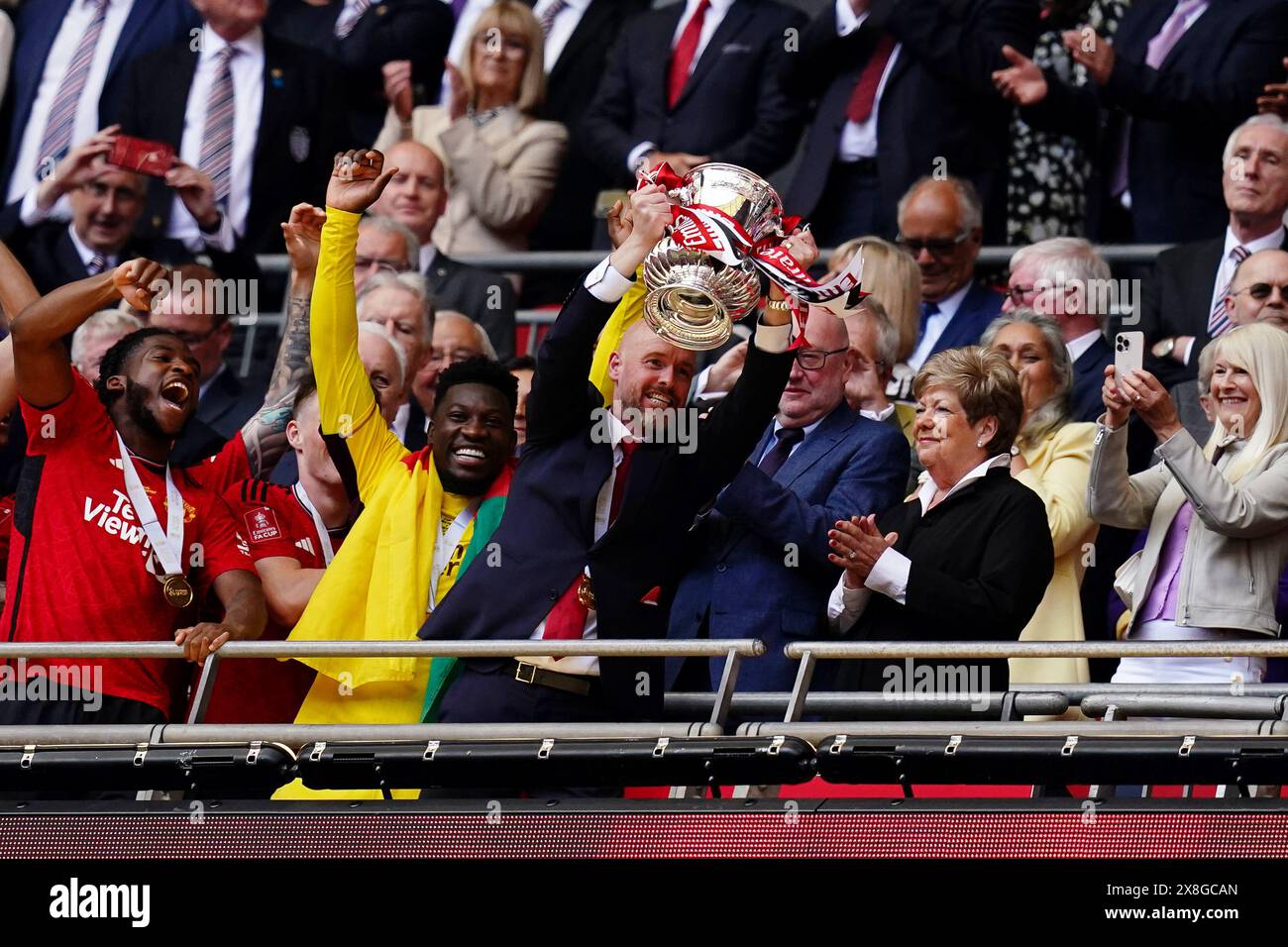 Manchester United manager Erik ten Hag lifts the FA Cup Trophy after ...