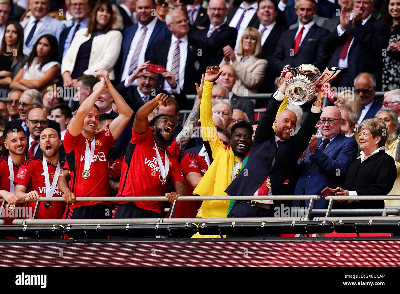 Manchester United manager Erik ten Hag lifts the FA Cup Trophy after ...