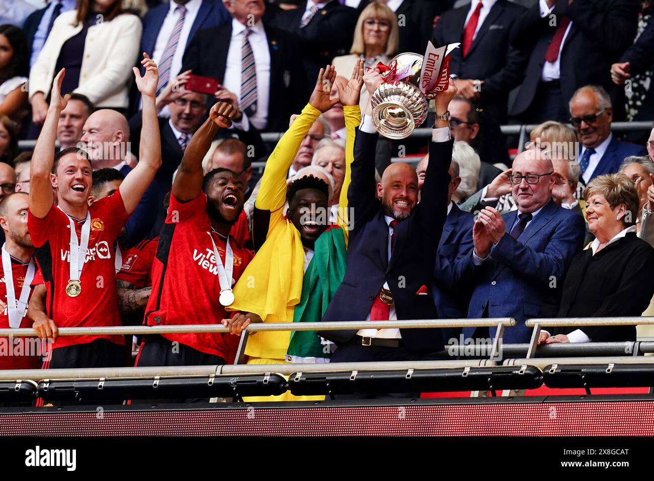 Manchester United manager Erik ten Hag lifts the FA Cup Trophy after ...