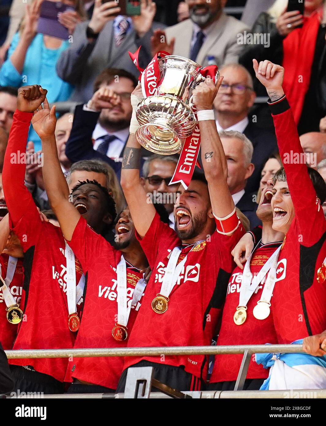 Manchester United's Bruno Fernandes lifts the FA Cup Trophy after ...