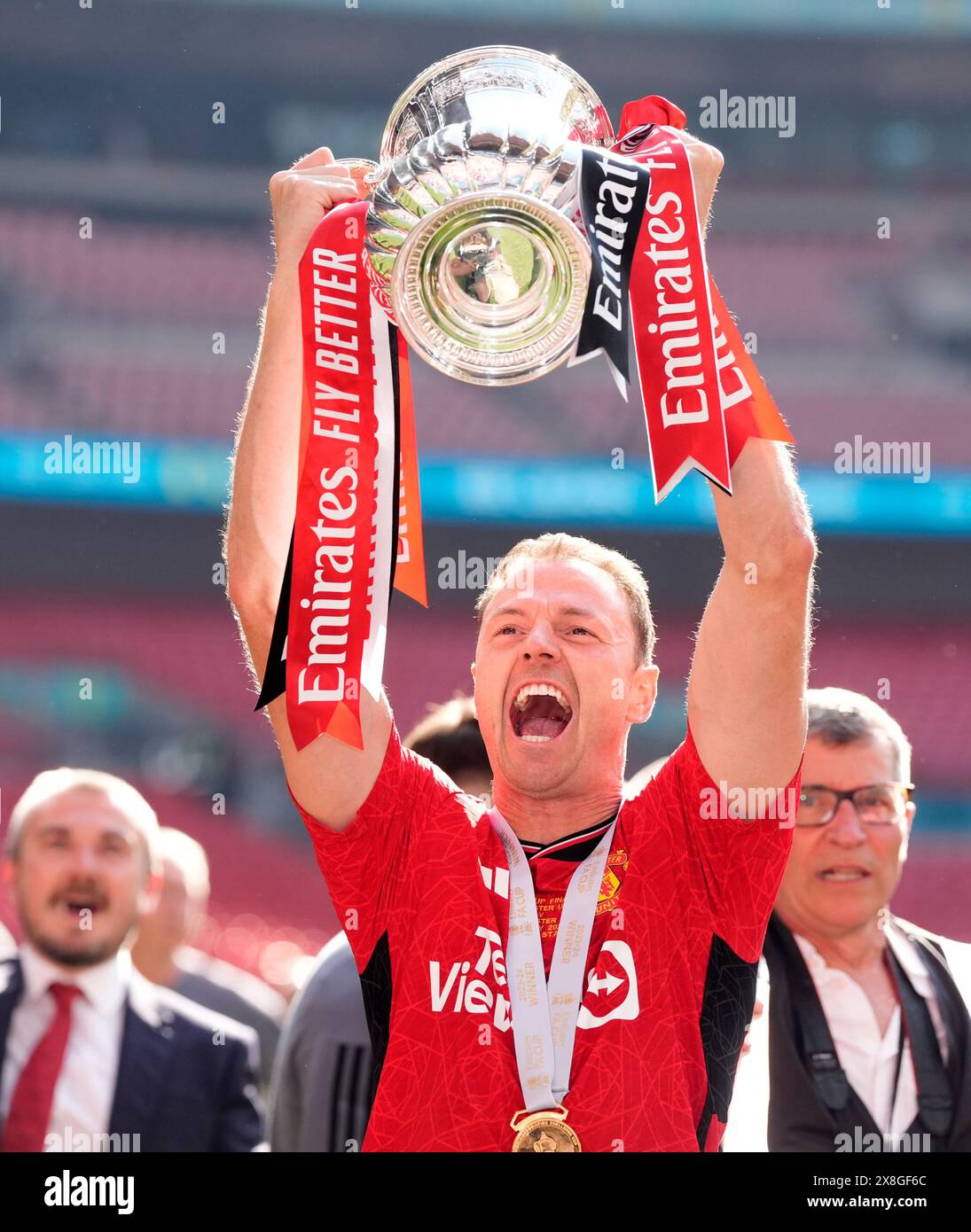Manchester United's Jonny Evans celebrates with the FA Cup Trophy after ...