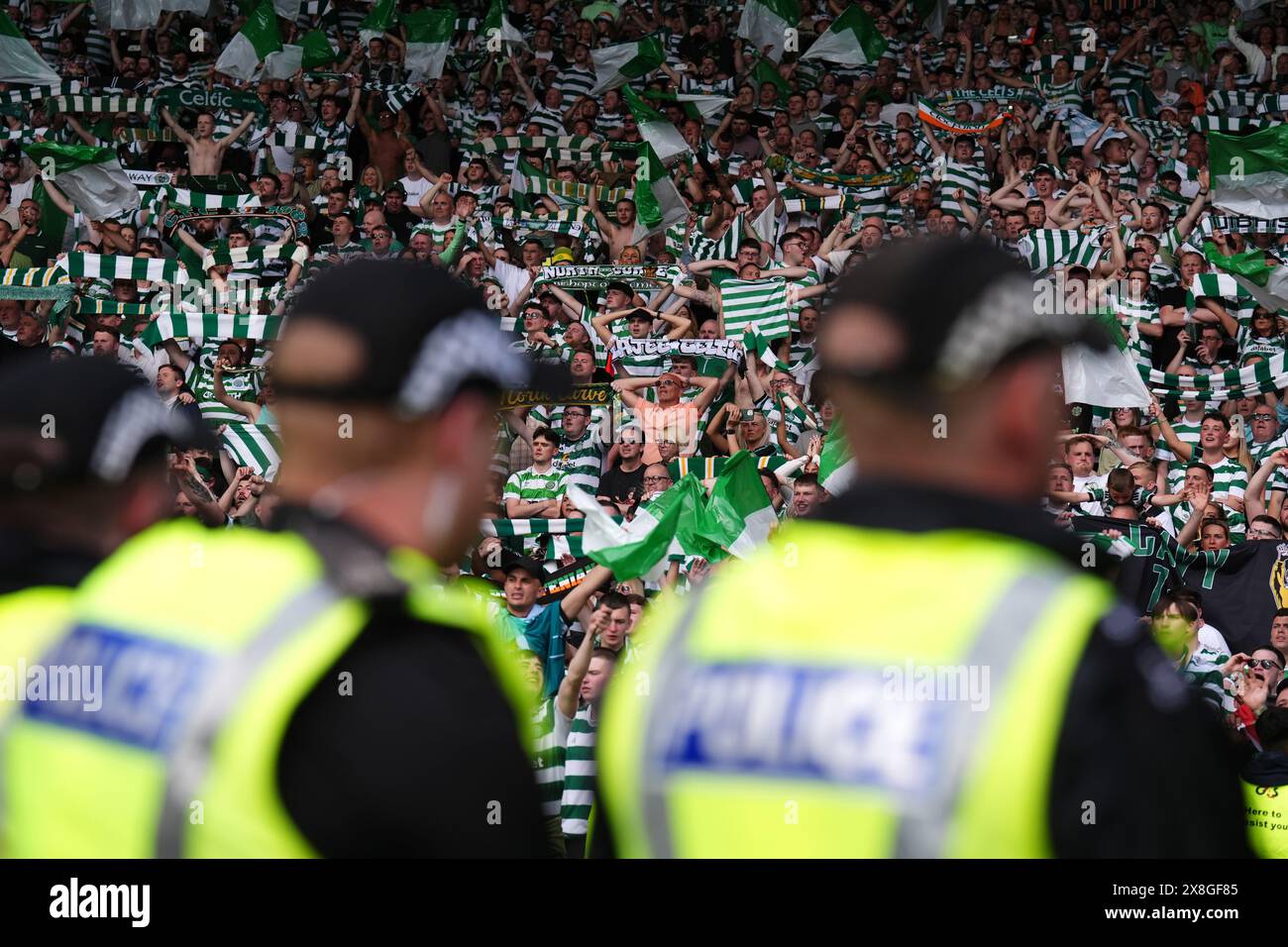 Celtic fans attempt to invade the pitch but are kept behind a police ...