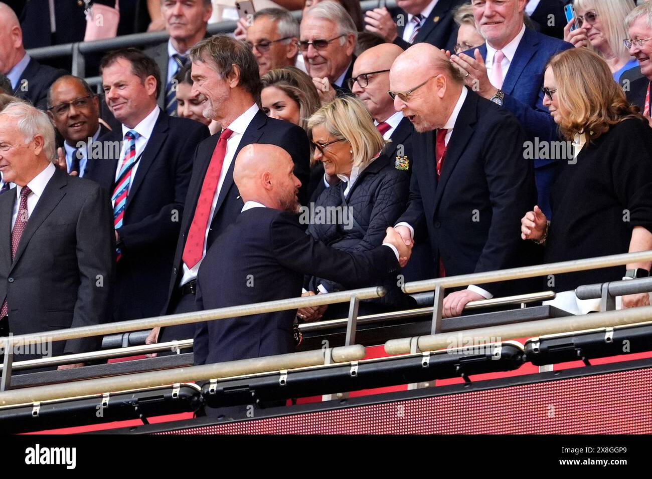 Manchester United manager Erik ten Hag (left) shakes hands with Avram ...