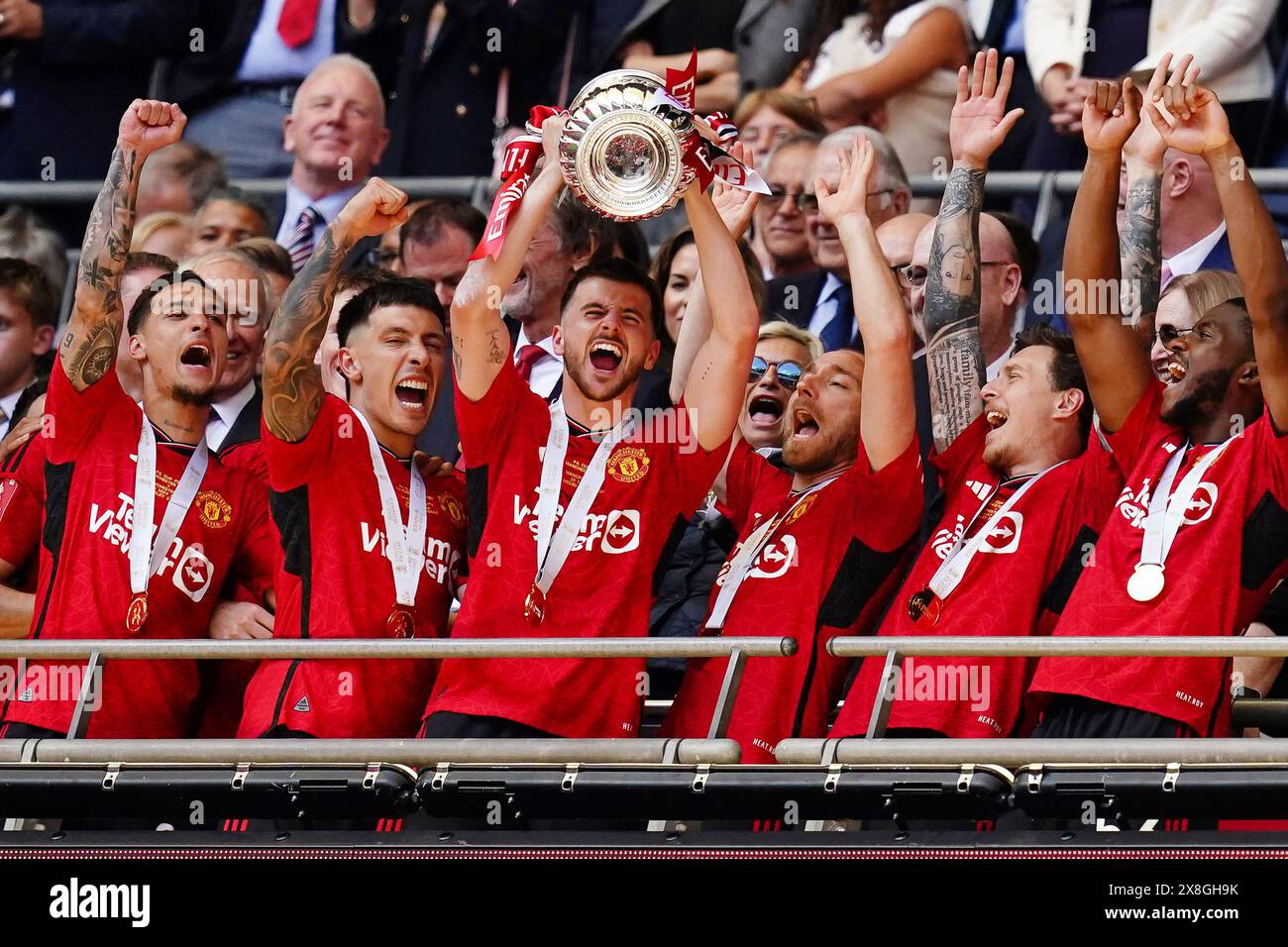 Manchester United's Mason Mount lifts the FA Cup trophy after winning ...