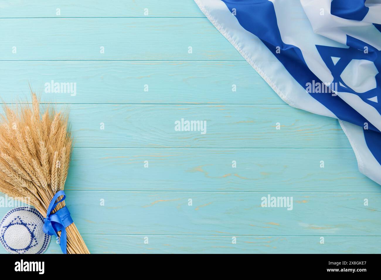 Shavuot jewish background. Ripe bouquet of wheat with blue ribbon with ...