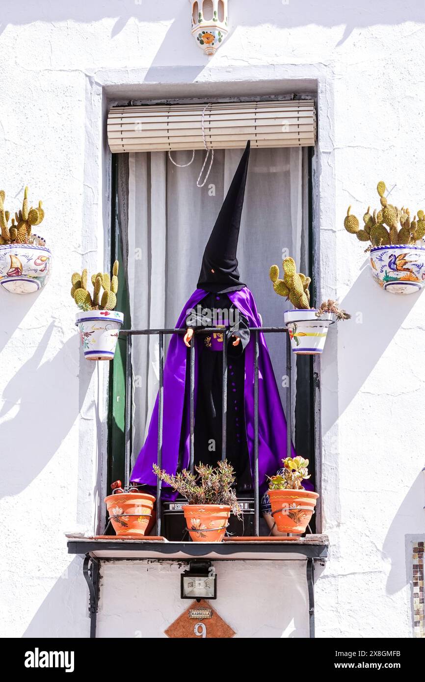 A doll made to look like a Nazarenos wearing traditional cone hat and ...