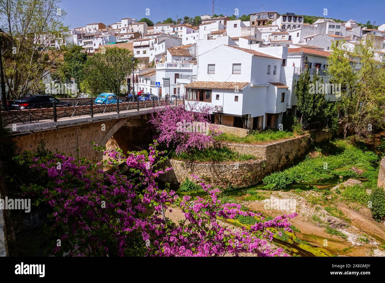 Vehicles cross a small stone bridge crossing the Rio Trejo river ...