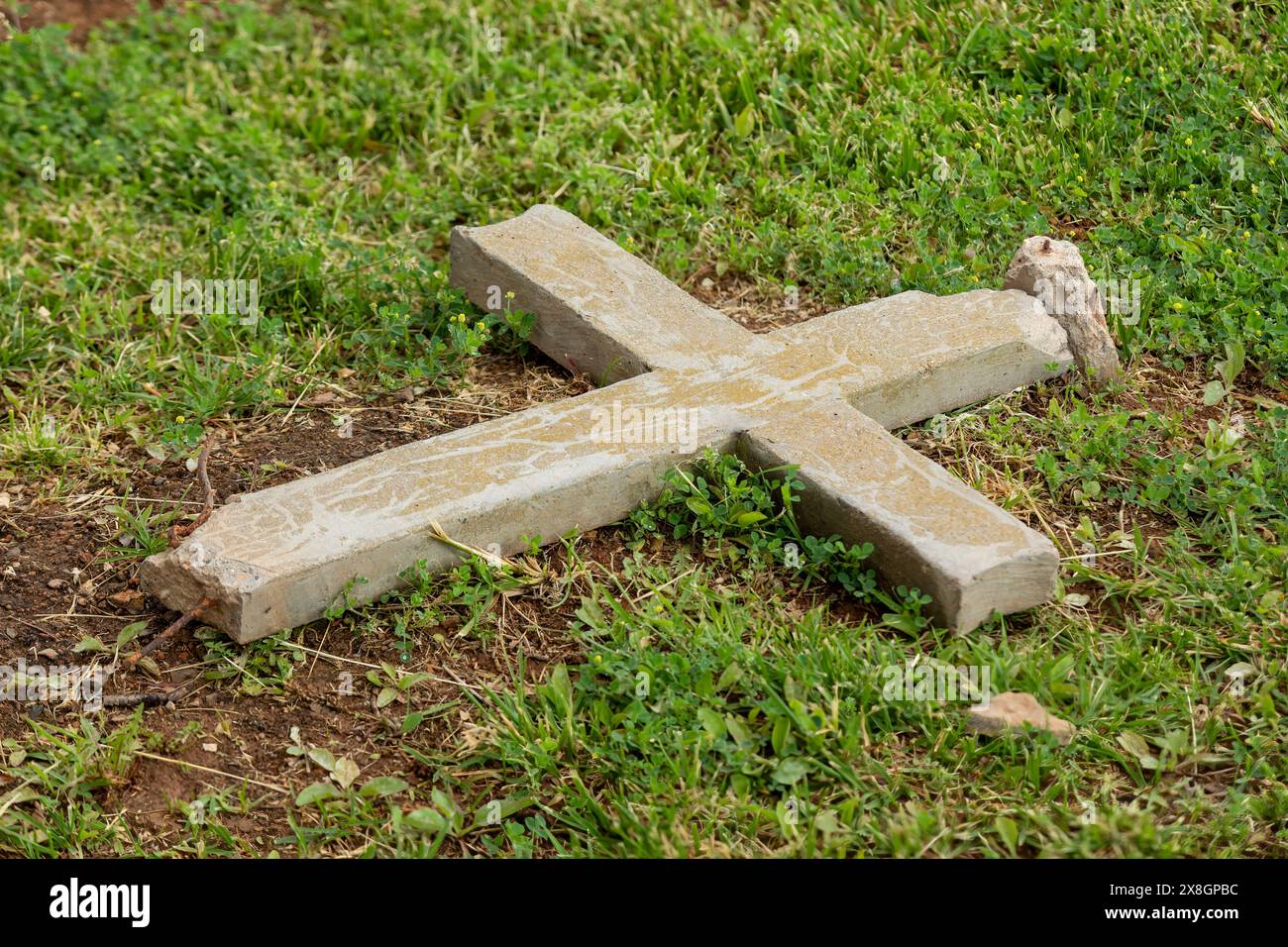 Desolate Remembrance: Broken Wooden Cross on a Grave Stock Photo - Alamy