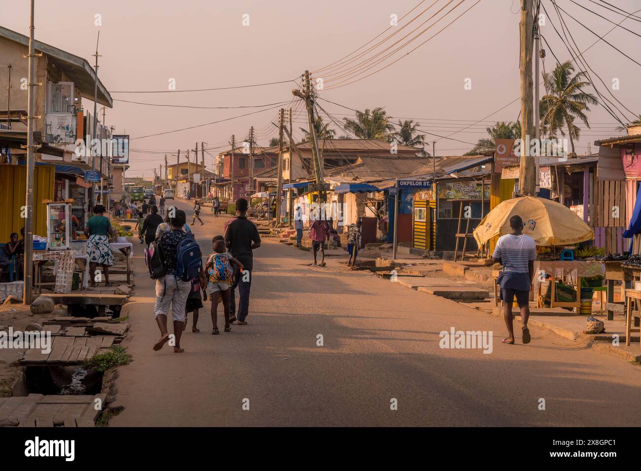 The African people with children walking on the dusty streets of Accra ...